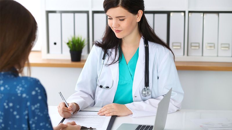 Single mother receiving advice from her doctor on fertility treatment